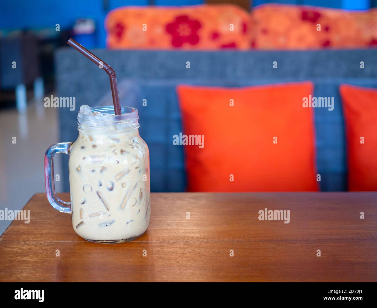Fresh milk tea in a glass placed on a wooden floor. with free space ...