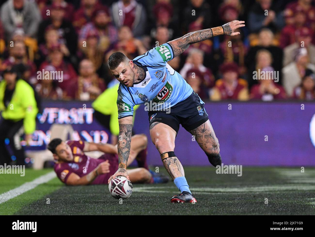 Josh Dugan of the NSW Blues gets past Maroons player Billy Slater to ...