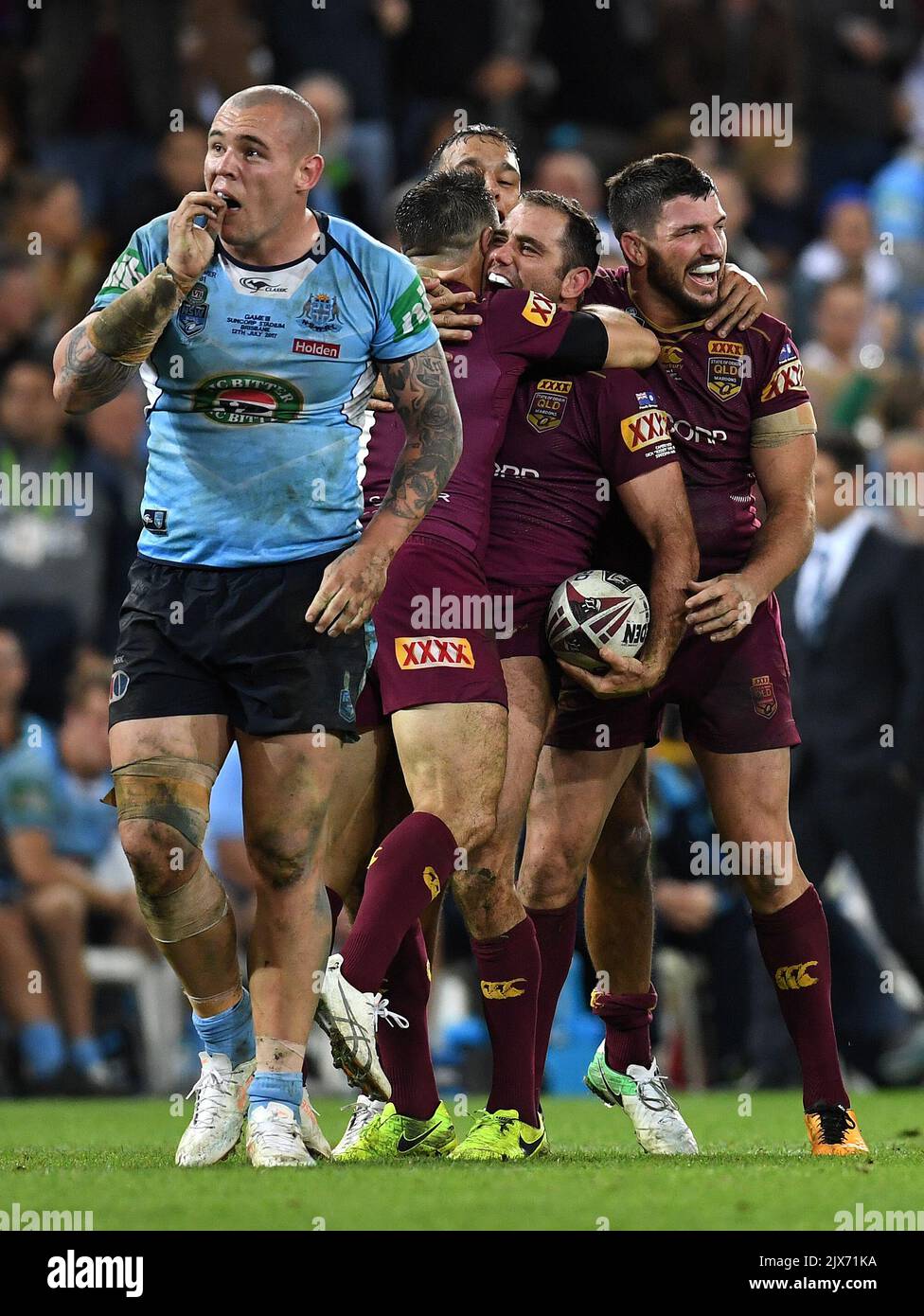 Captain of the Queensland Maroons Cameron Smith (centre) and teammates ...