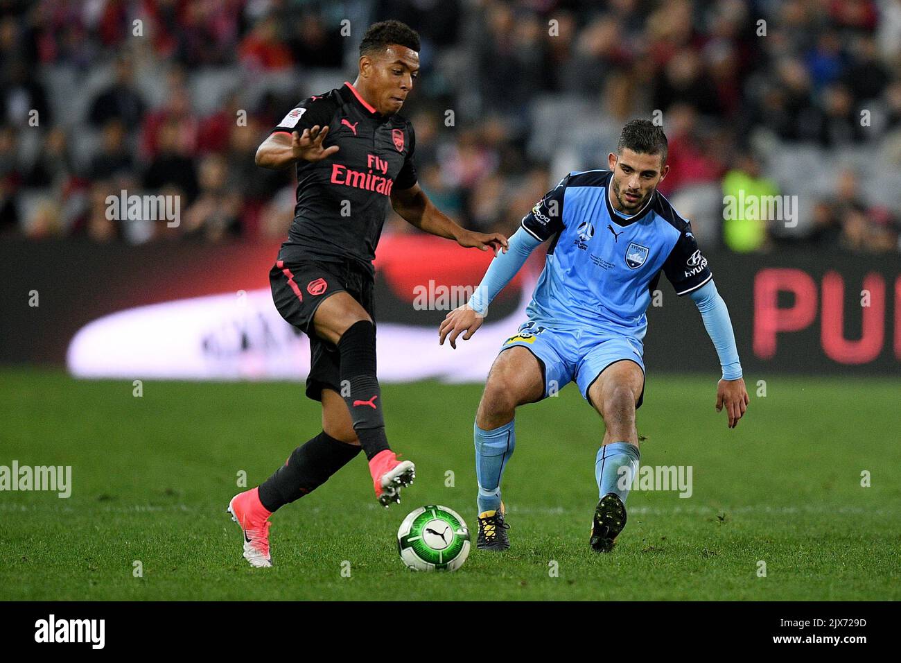 Donyell Malen of Arsenal competes for possession with Nicola Kuleski of ...