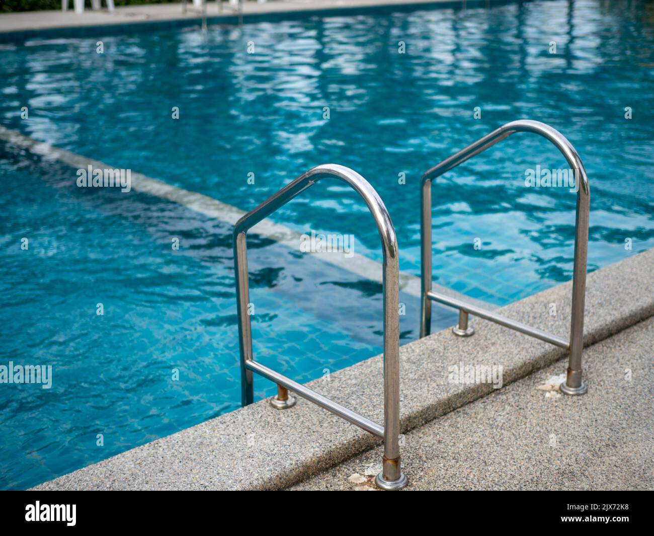Stainless steel stairs to the pool. handrails up and down the pool ...