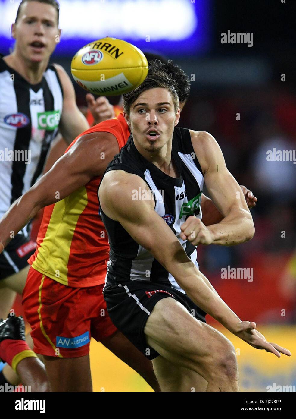 Josh Thomas of the Magpies handballs during the Round 17 AFL match ...