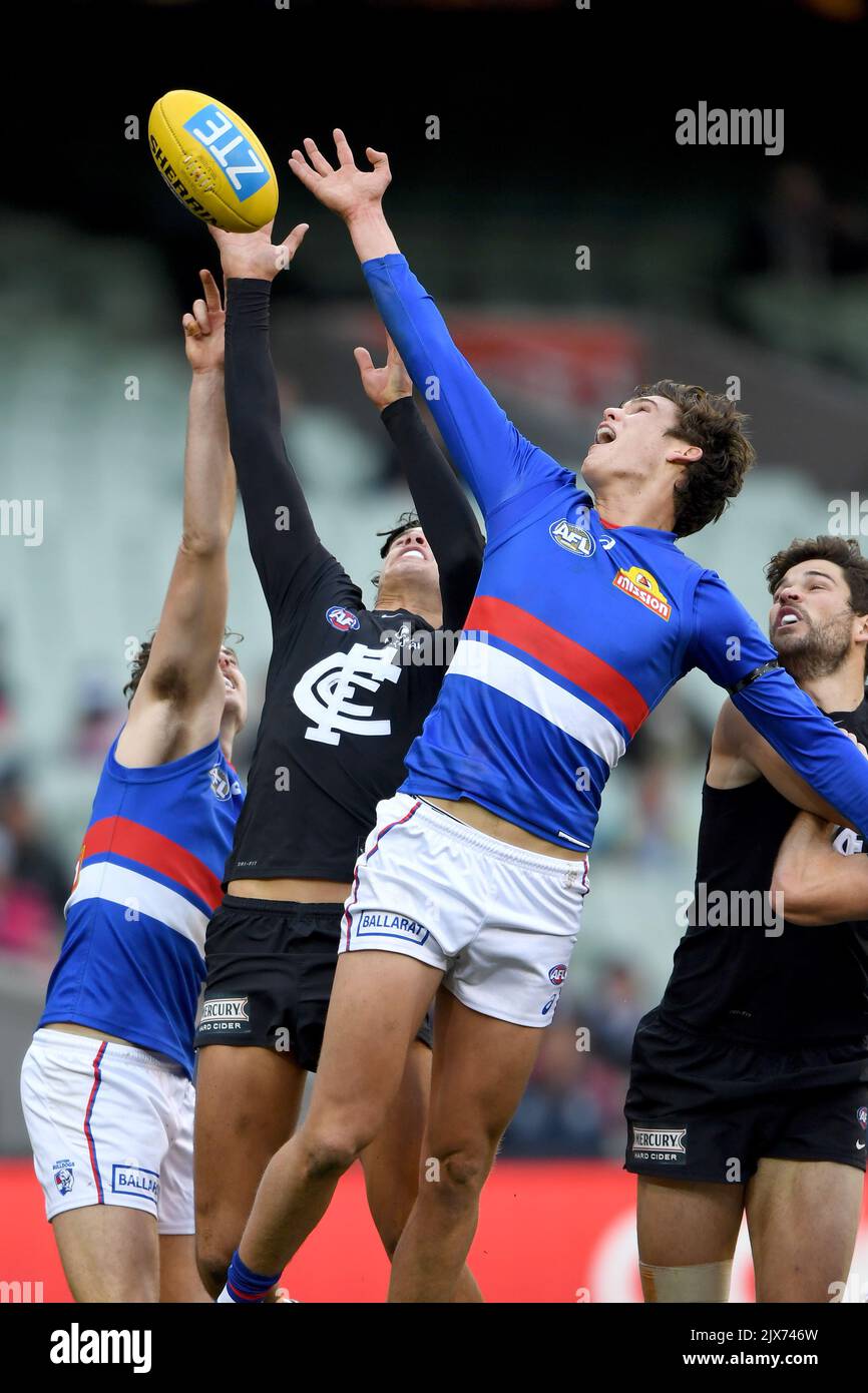 Lewis Young of the Bulldogs (right) plays his first senior match ...