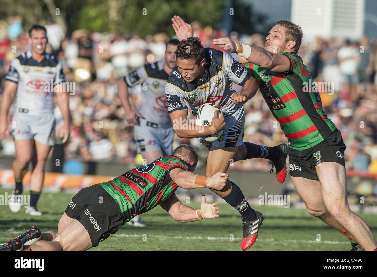 NQ Cowboy Te Maire Martin is tackled by the Rabbitohs defence during ...