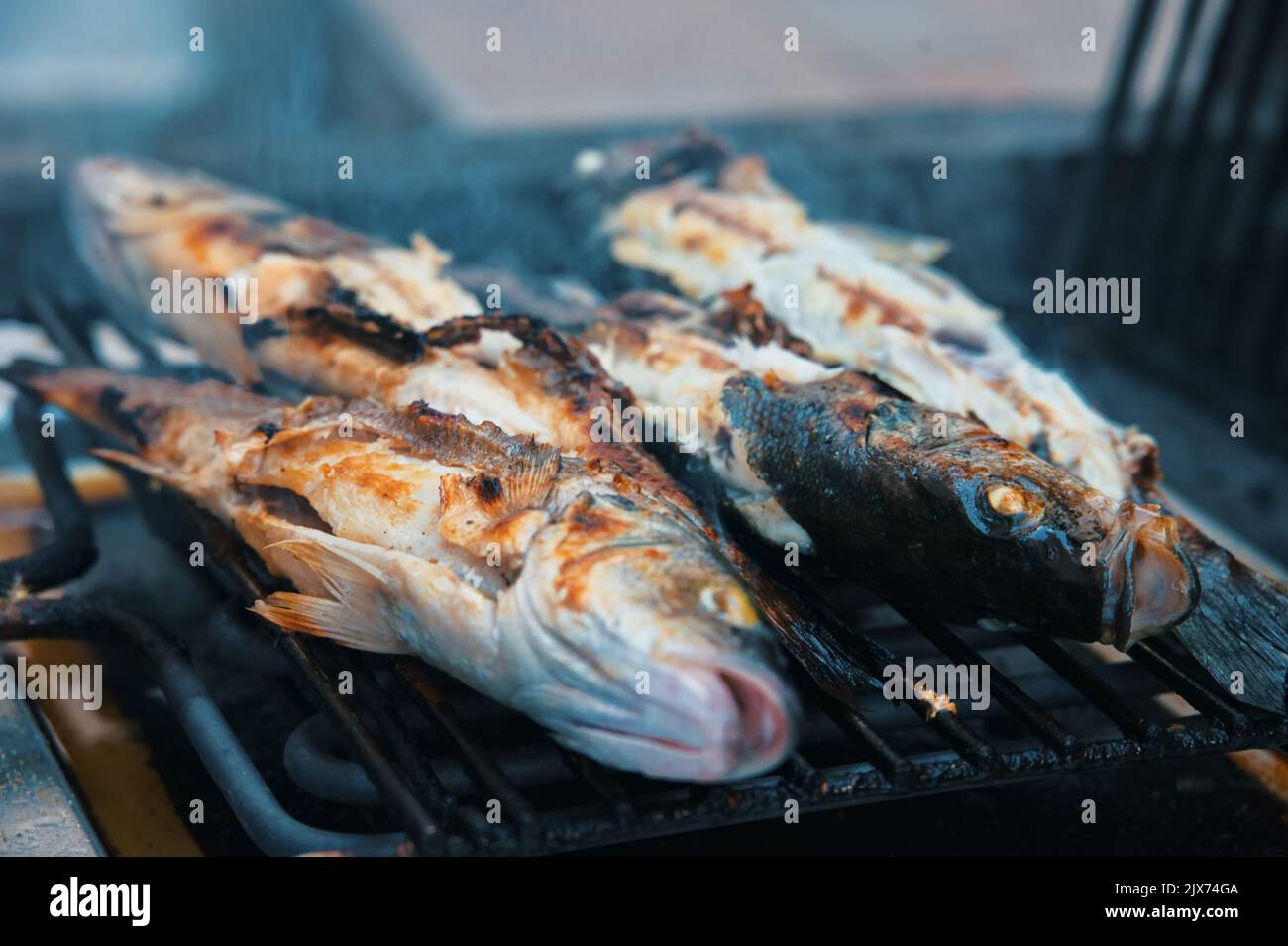 Closeup of grilled fish on gridiron Stock Photo - Alamy