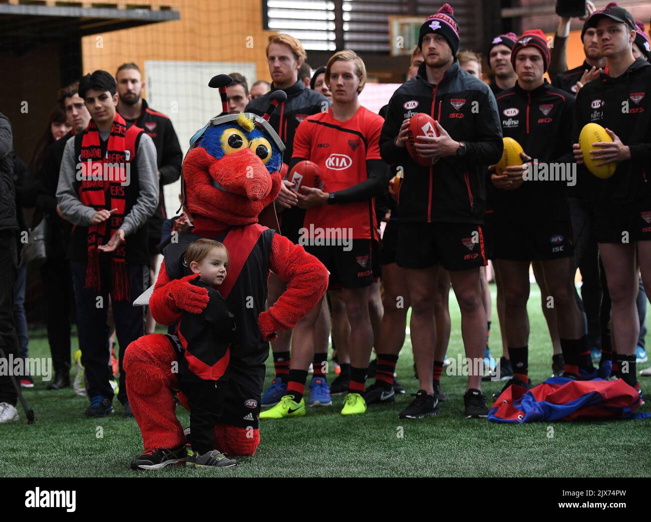 Essendon mascot Skeeta hugs three-year-old Holden Bennett as the ...