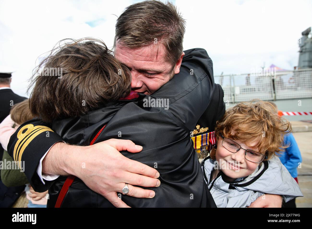 Executive Officer Duncan Macrae is greeted by family and friends after ...