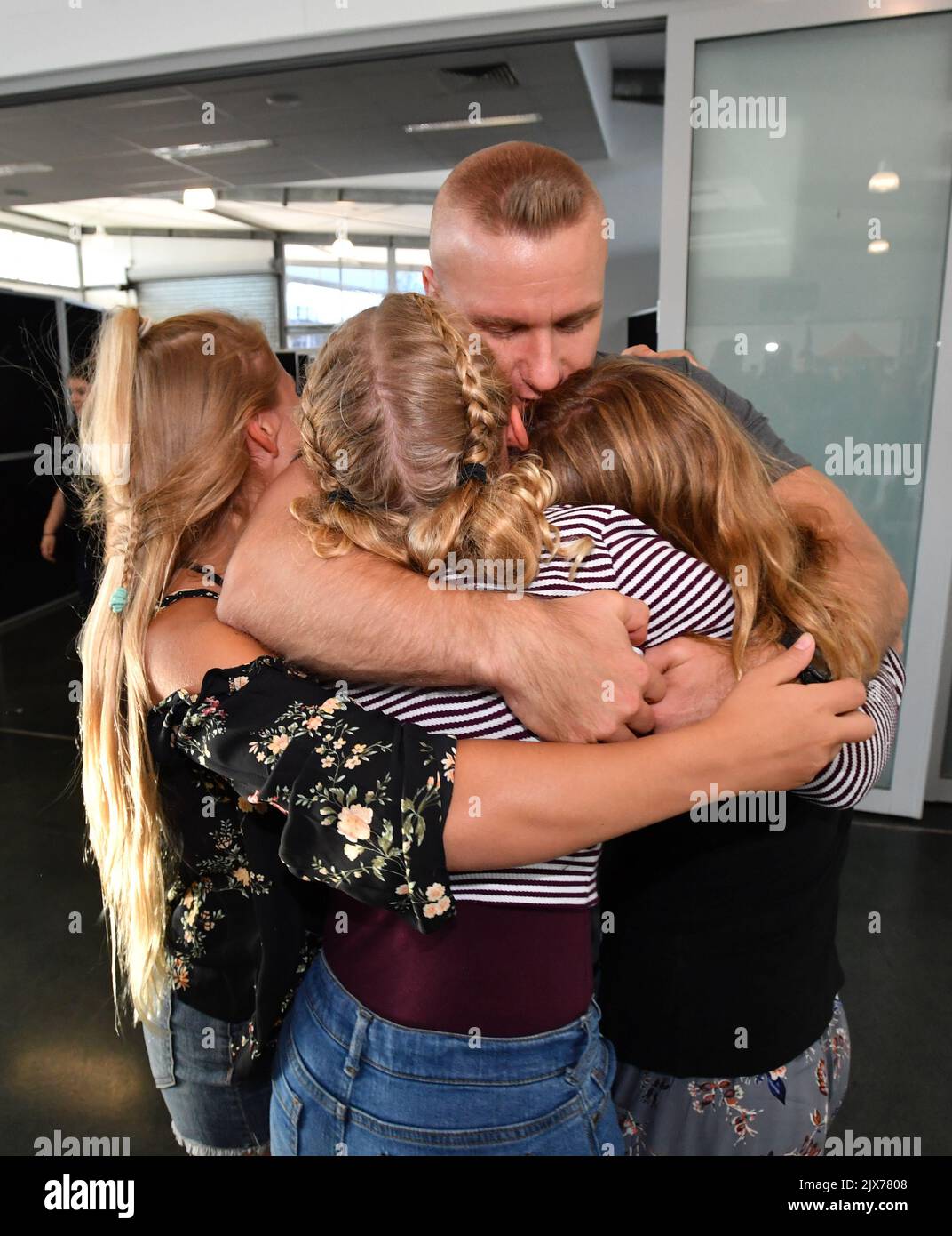 Commander Shane Tanner hugs his family after he arrived on the USS ...