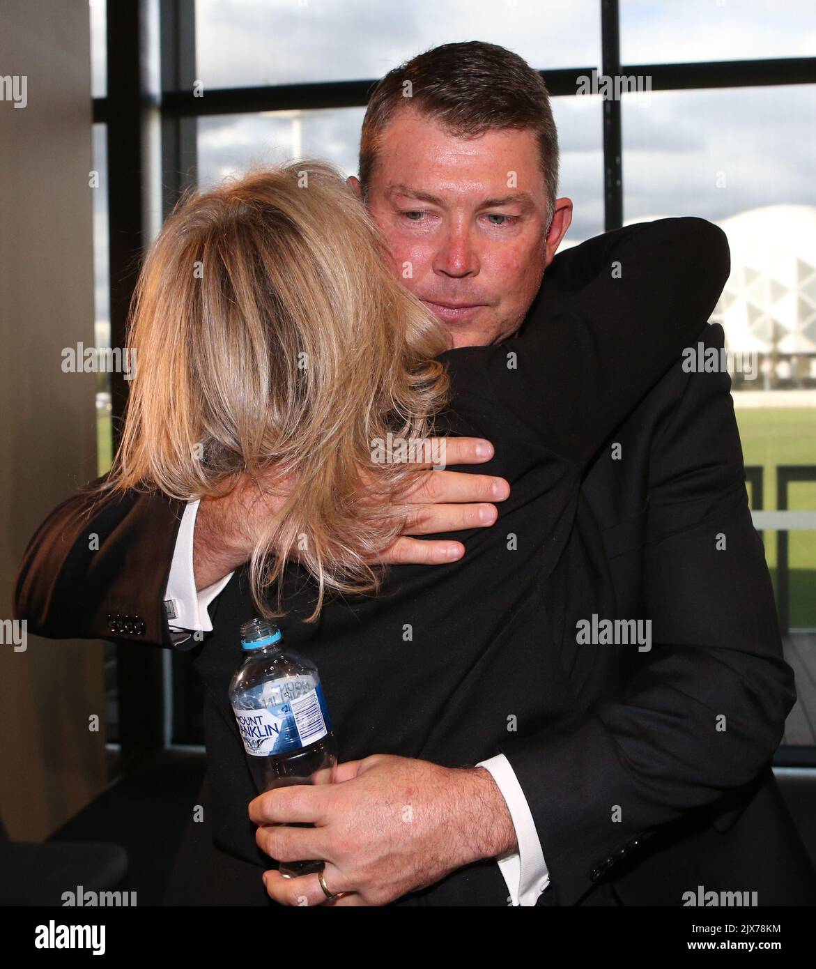 Collingwood AFL club CEO Gary Pert hugs his wife Andi after announcing ...