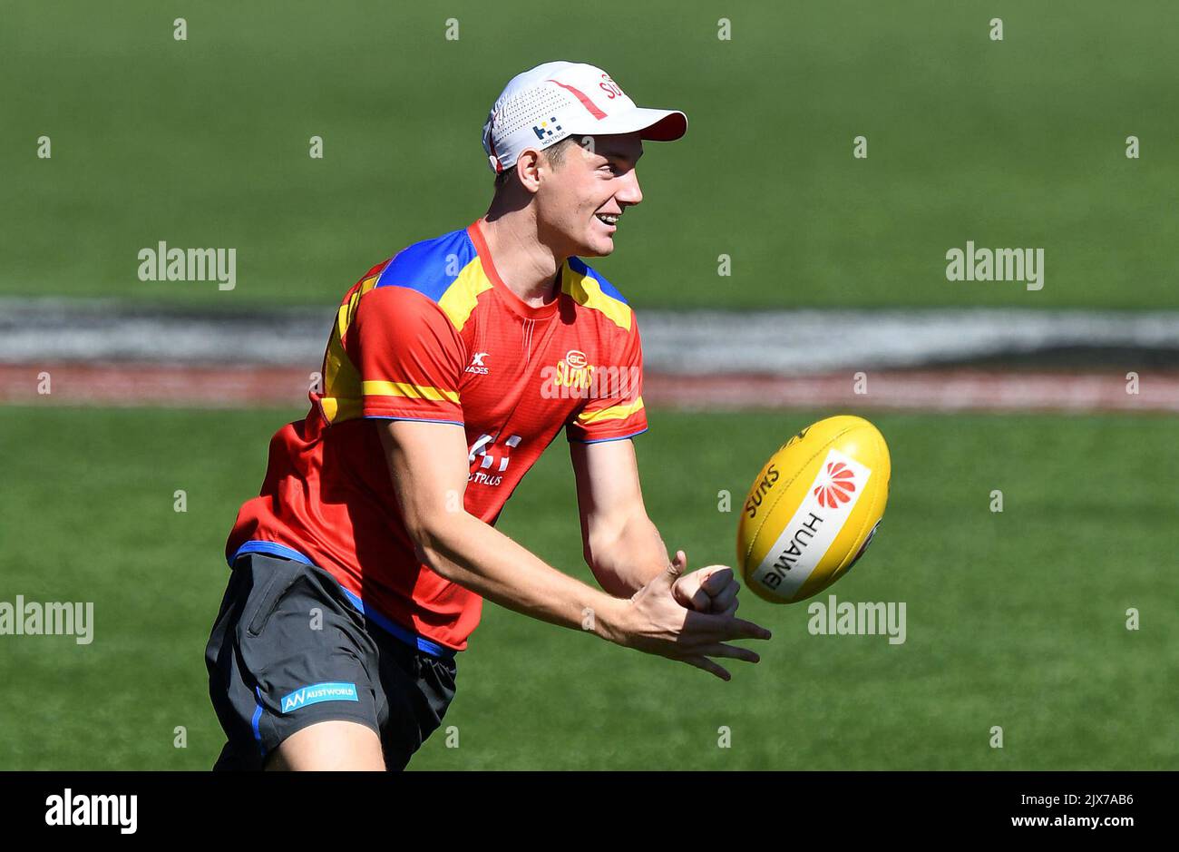 Max Spencer handballs during the Gold Coast Suns training session at ...