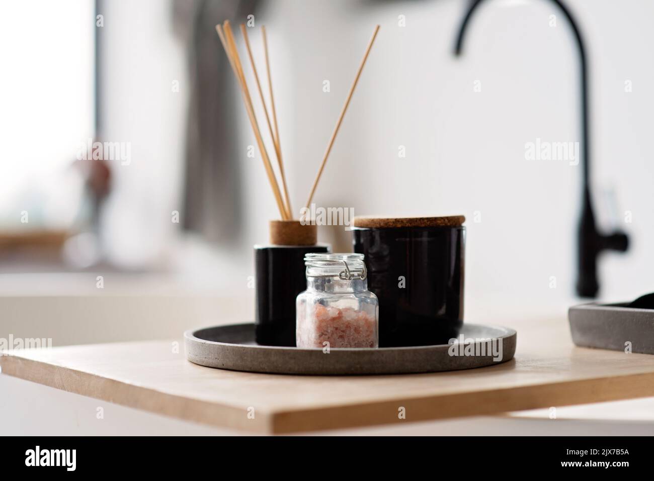 Spa treatment composition on wooden table, diffuser candles and pink ...