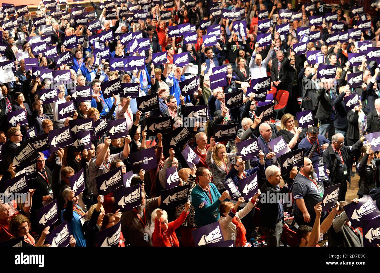 Delegates and Labor members rise for a photo opportunity for the motion ...