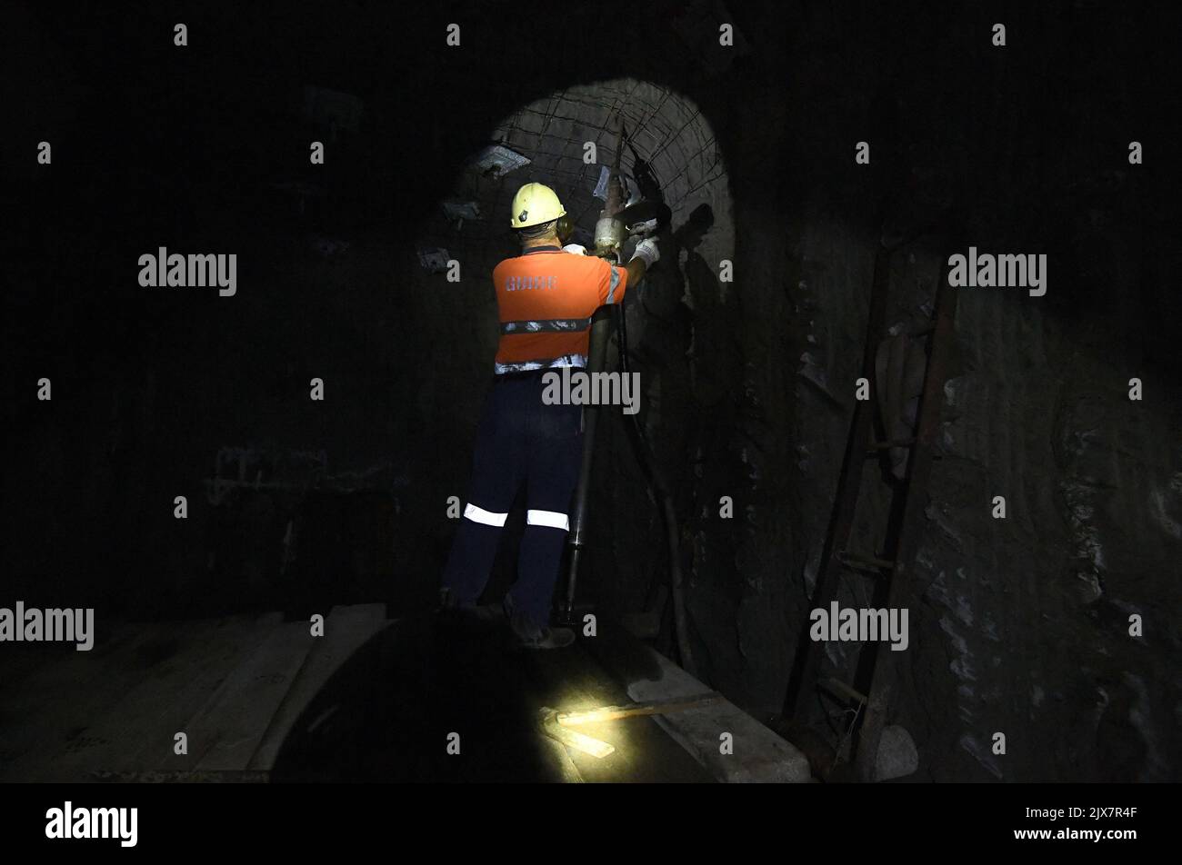 A guide demonstrates rock drilling during a tour of the Hard Times Mine ...