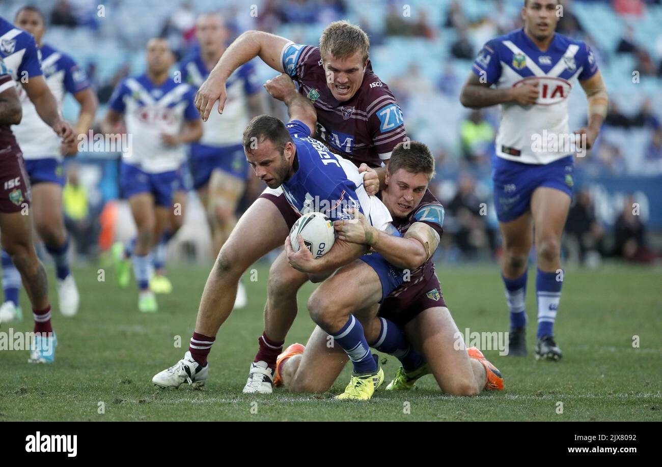 Matthew Frawley of the Bulldogs is tackled by Sea Eagles defence during ...