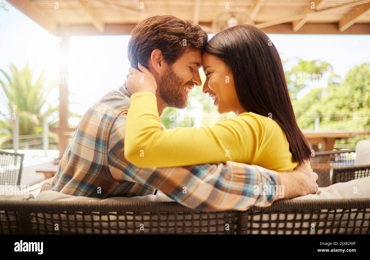 Happy, smile and love couple relax in home backyard patio in sun ...