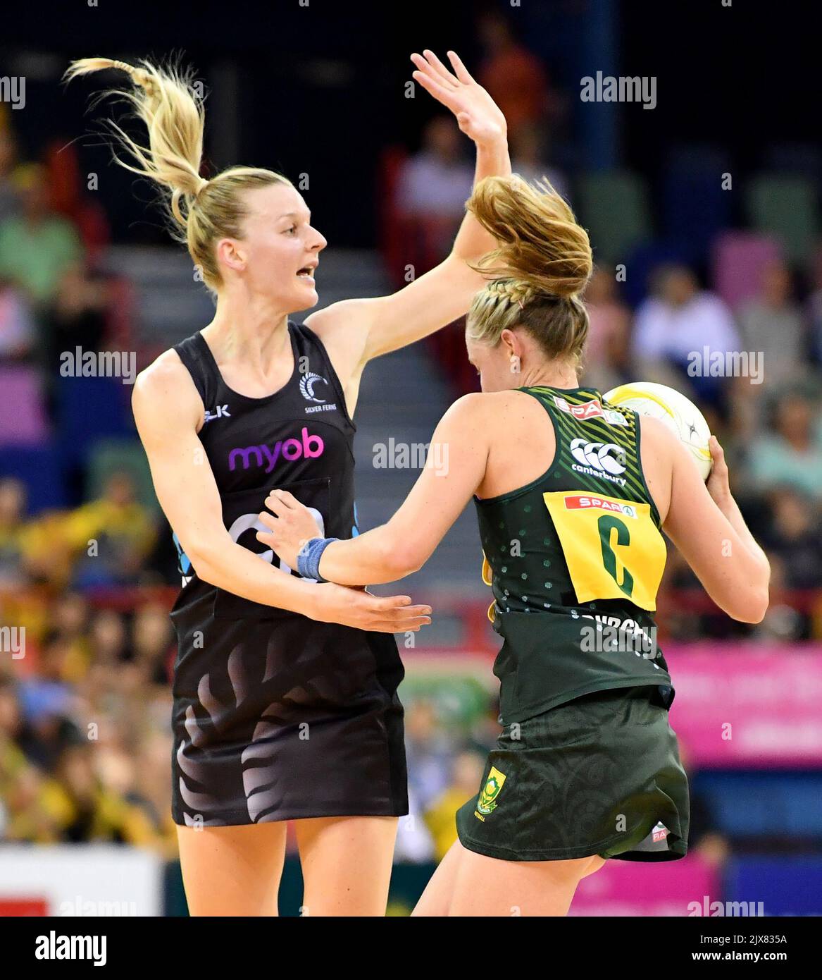 Katrina Grant of New Zealand collides with Erin Burger of South Africa ...