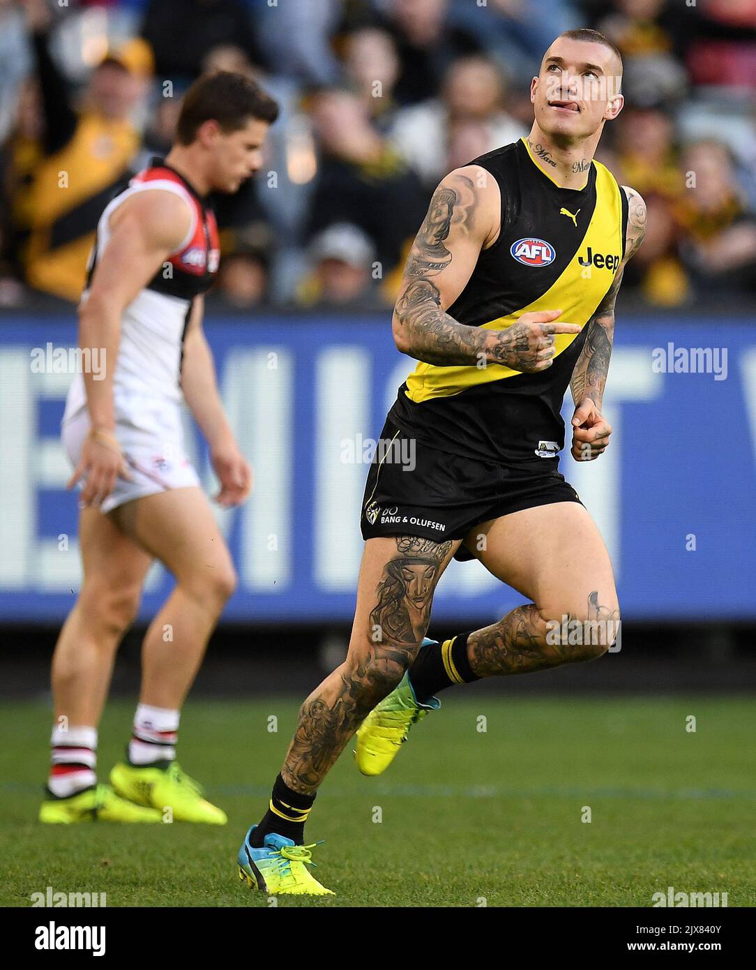 Dustin Martin of the Tigers (right) reacts after kicking a goal during ...