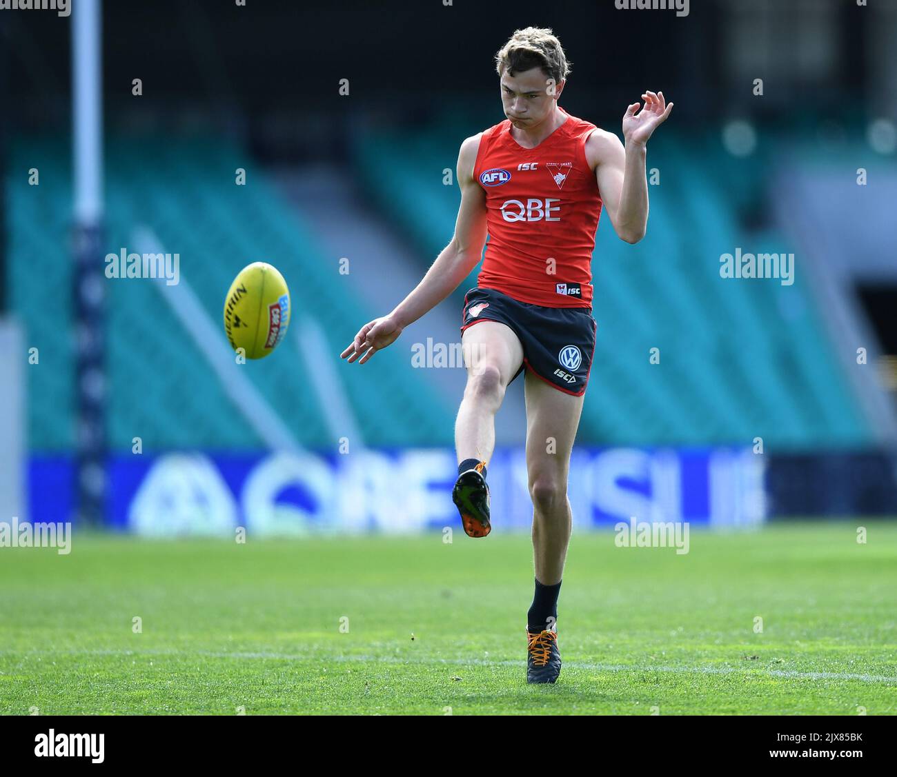 Will Hayward of the Sydney Swans kicks a ball during a team training ...