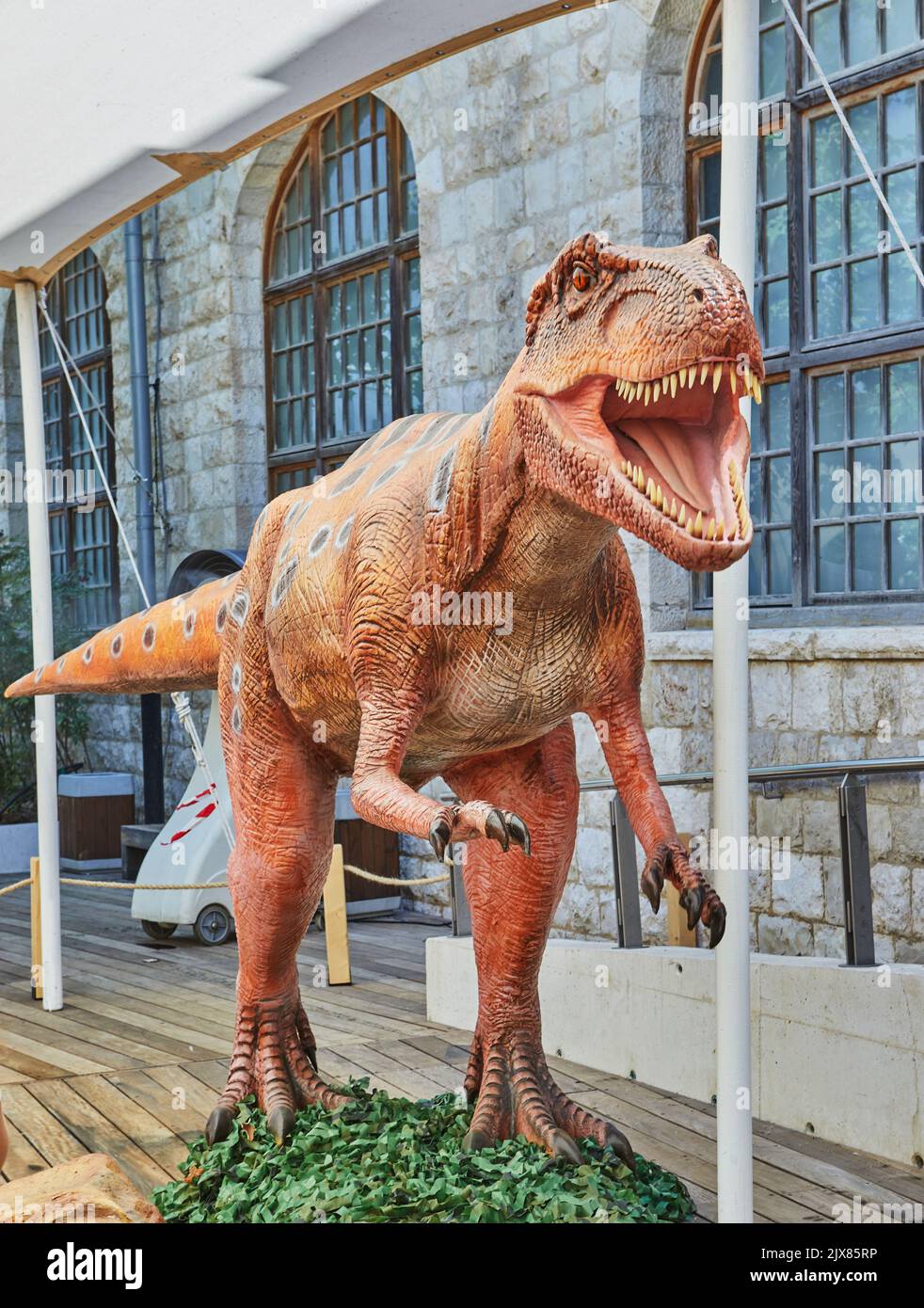 Life-size dinosaur figure in the park is an approximation to reality ...