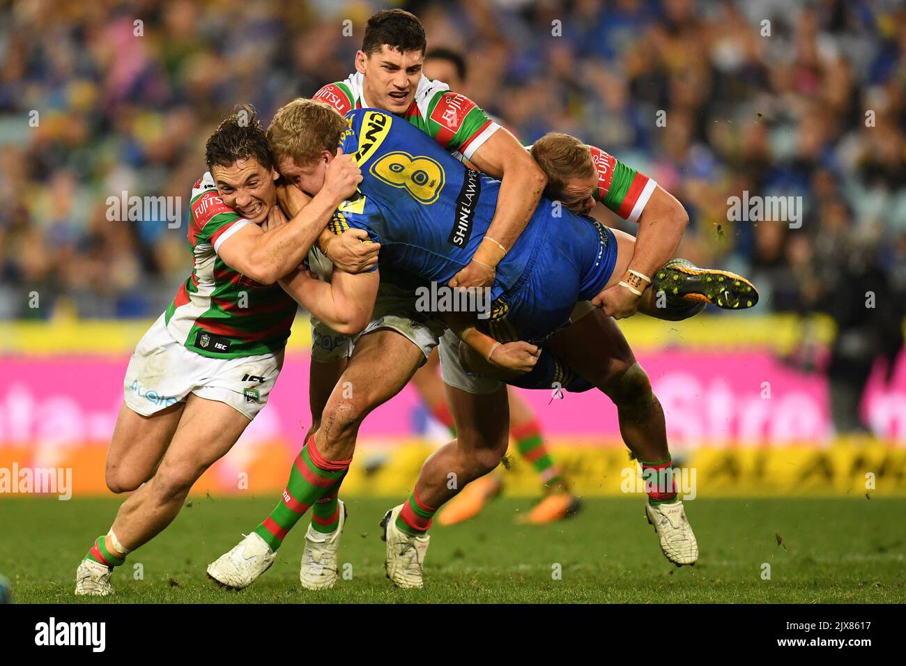 Daniel Alvaro of the Eels is tackled by Kyle Turner, Jason Clark and ...