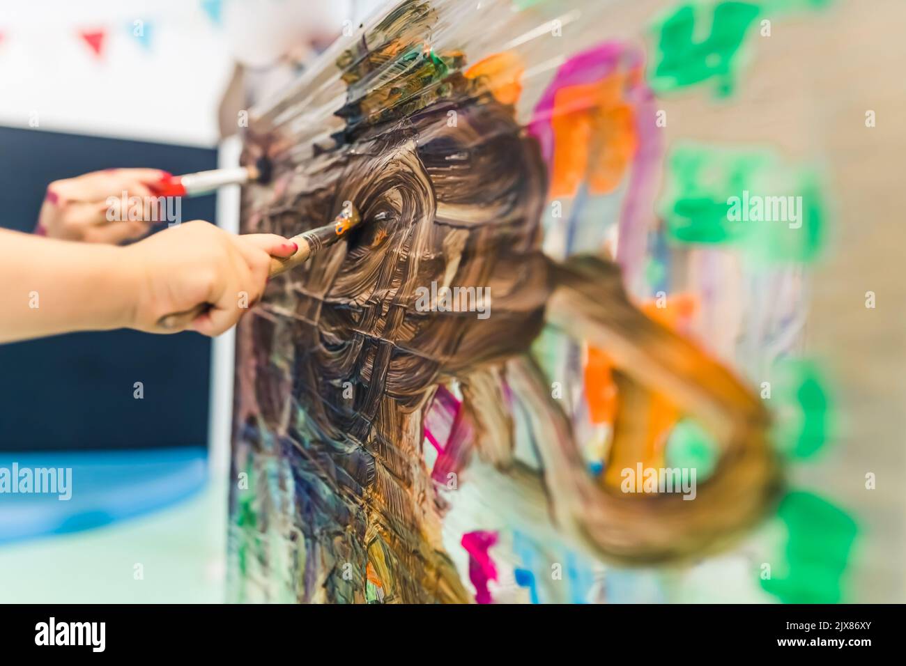 Close up toddlers hands. Cling film painting. Children painting with ...