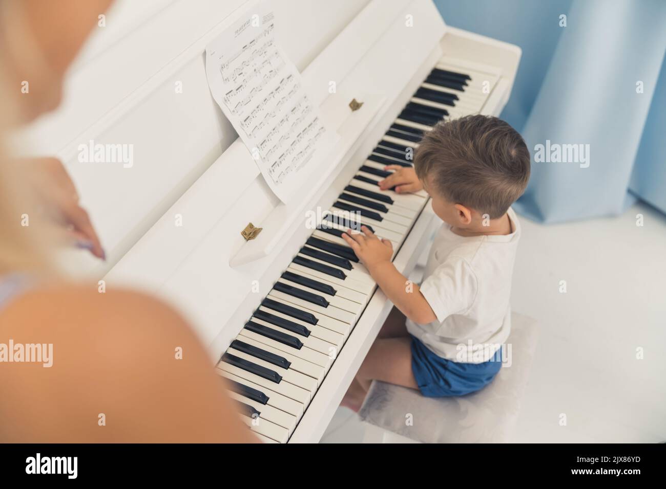 Musical instruments and children. Horizontal indoor shot from mother's ...