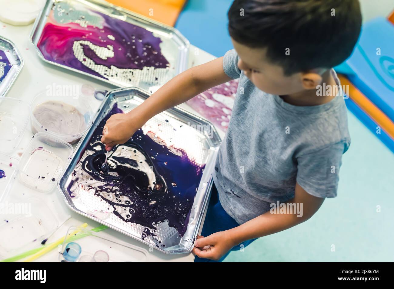 Sensory play for brain development at nursery school. Toddlers playing ...