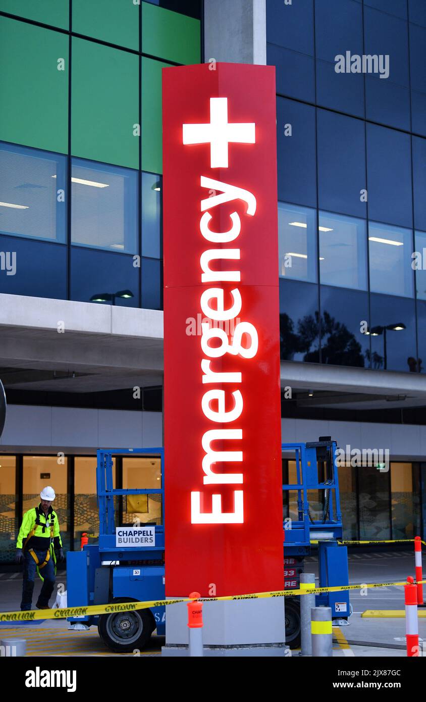 Construction workers unveil the emergency sign during the official ...