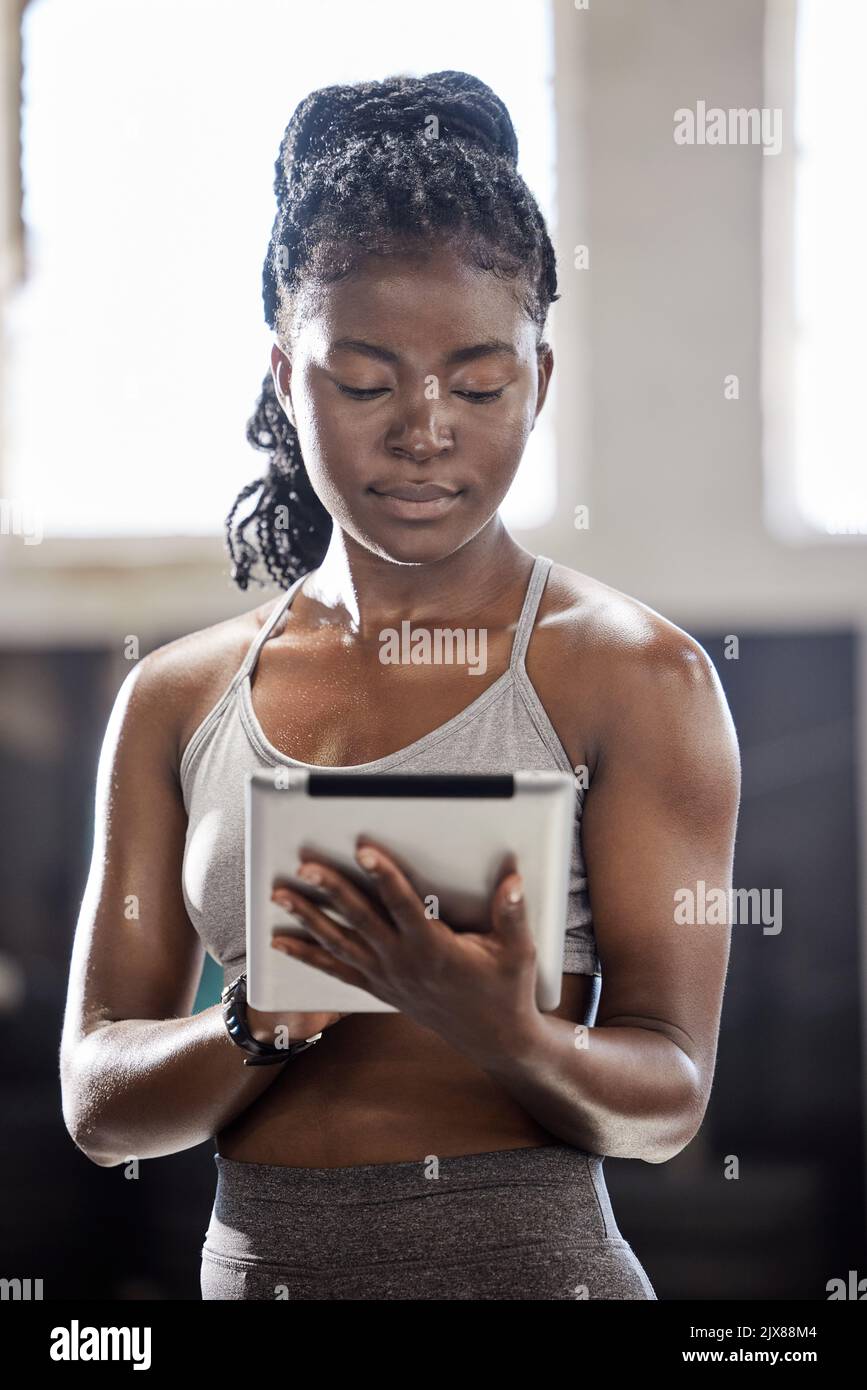 Personal trainer with digital tablet, mobile wellness technology in gym ...