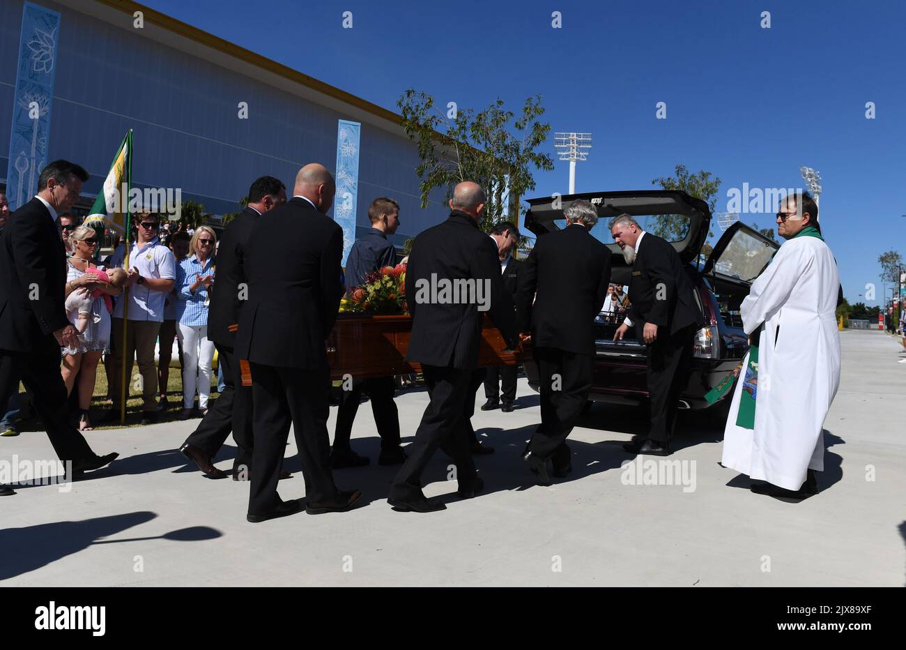 13 year-old Brayden Mercer (centre), carries the coffin of his father ...