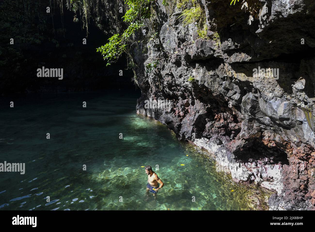 A man is seen swimming in the To Sua Ocean Trench water hole in ...