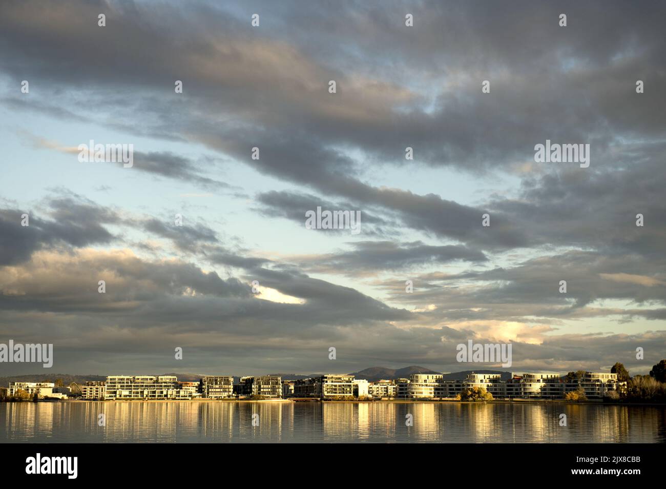 The Kinston foreshore is reflected on Lake Burley Griffin in Canberra ...