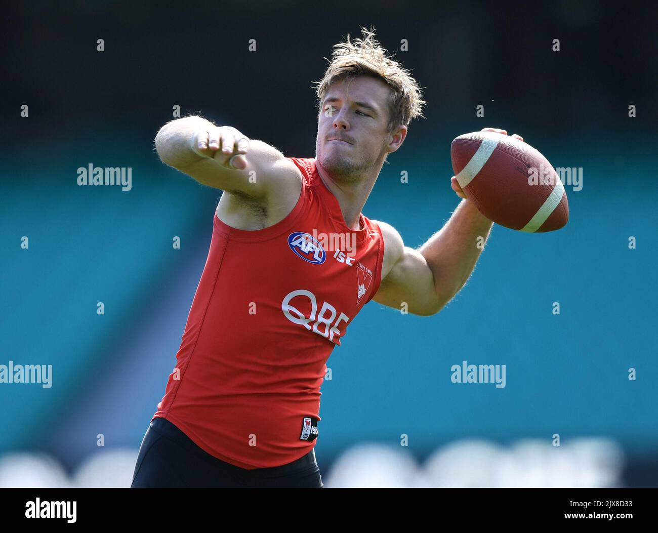 Luke Parker of the Sydney Swans throws a NFL ball during a team ...