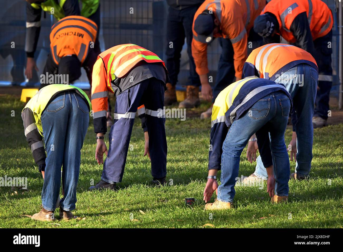 Construction workers take part in group exercise before starting their ...