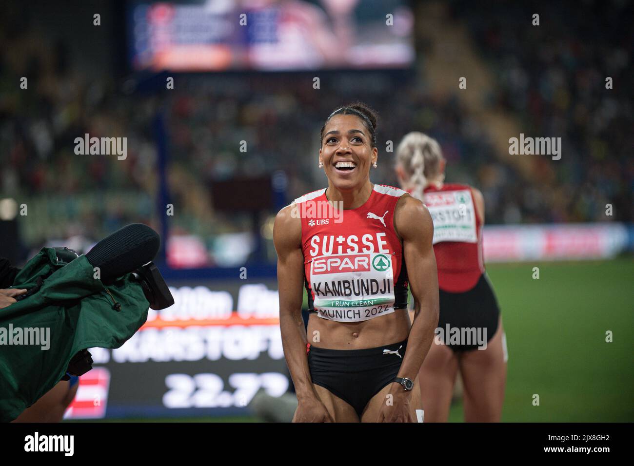 Mujinga Kambundji with her country's flag as the winner of the 100 ...