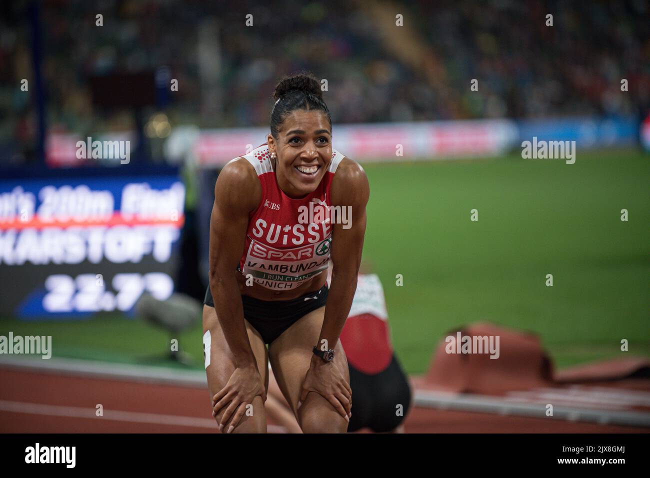 Mujinga Kambundji with her country's flag as the winner of the 100 ...