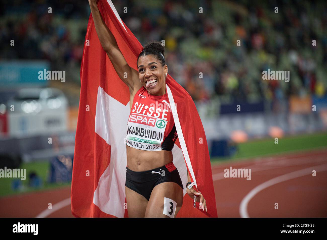 Mujinga Kambundji with her country's flag as the winner of the 100 ...