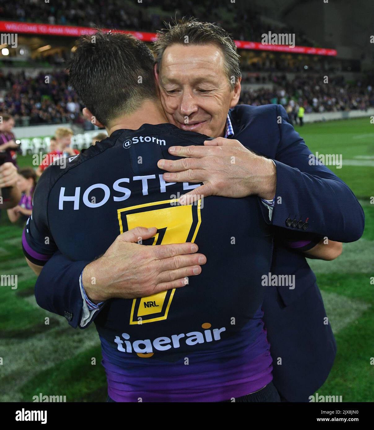 Coach of the Storm Craig Bellamy (right) kisses Cooper Cronk after the ...