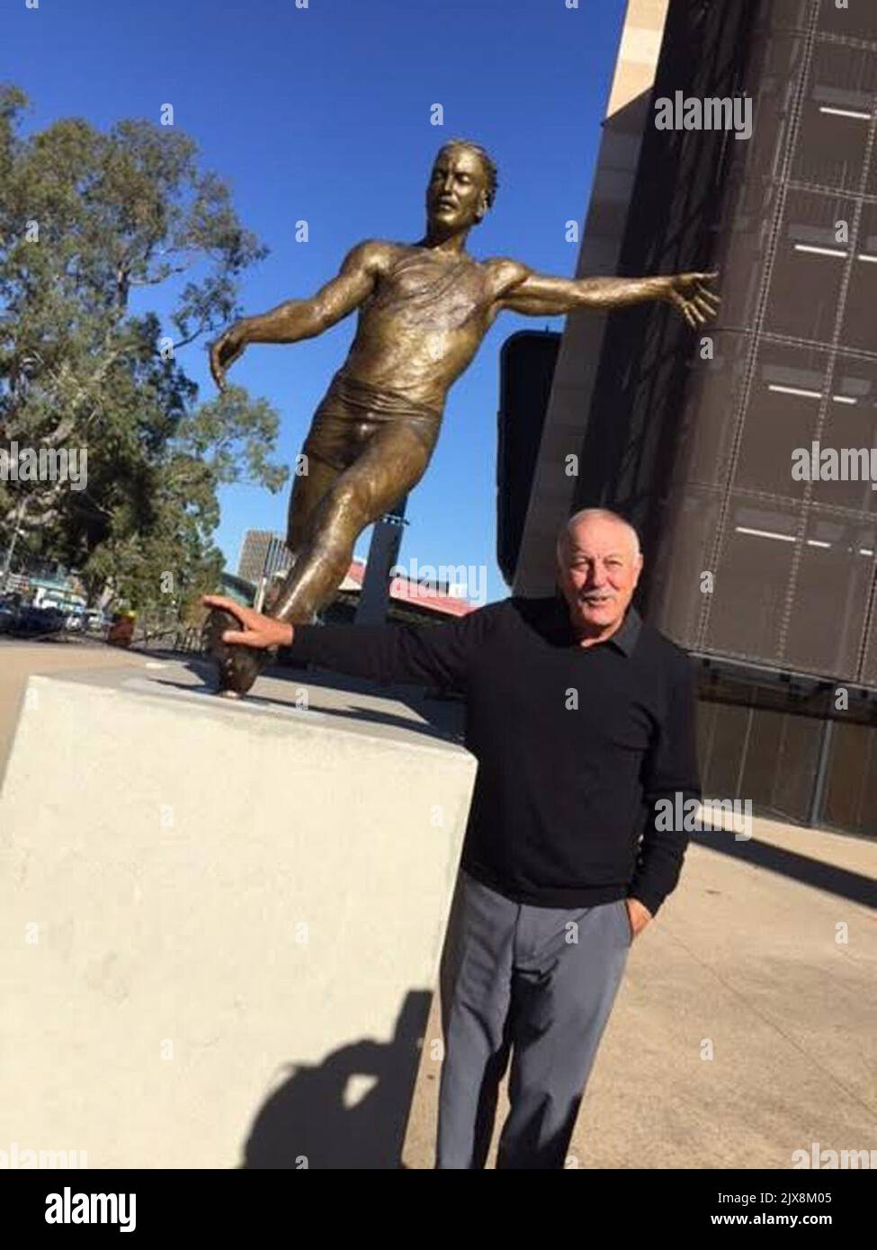 Malcolm Blight poses with his statue on Wednesday, June 21, 2017. The ...