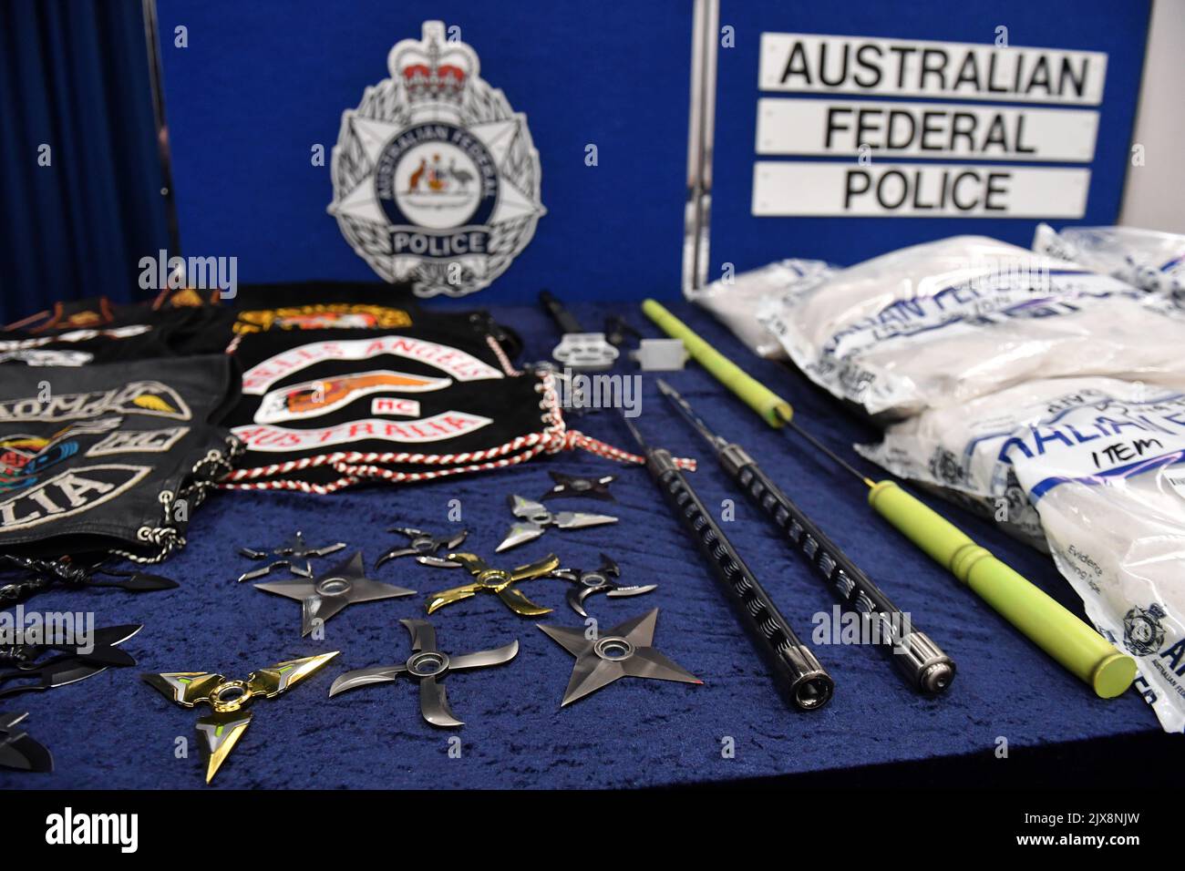 Bags of ephedrine, bikie weapons and bikie vests are seen at a press ...