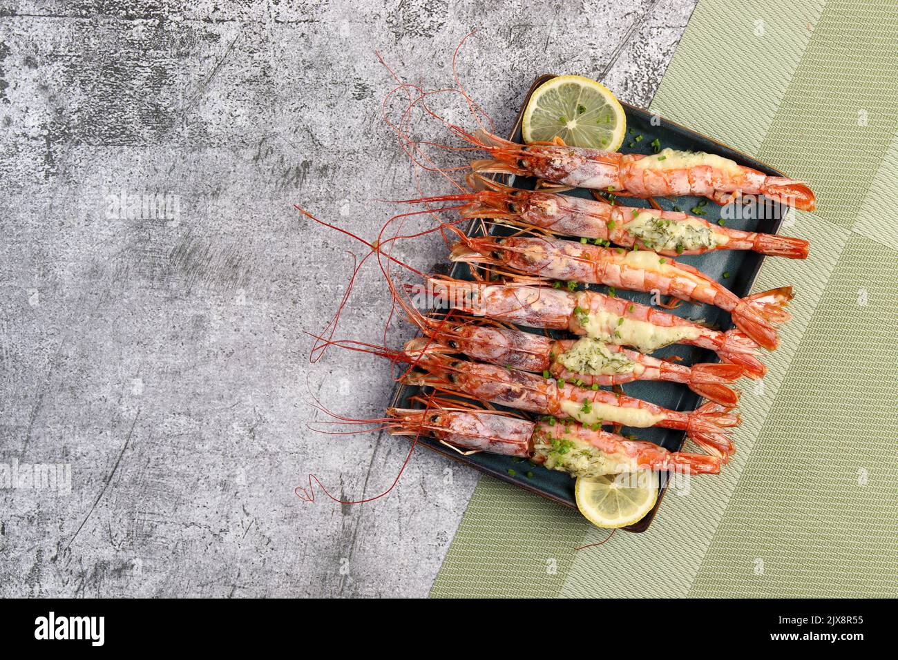 Сheese stuffed Argentinian red prawns with garlic and herbs on a ...