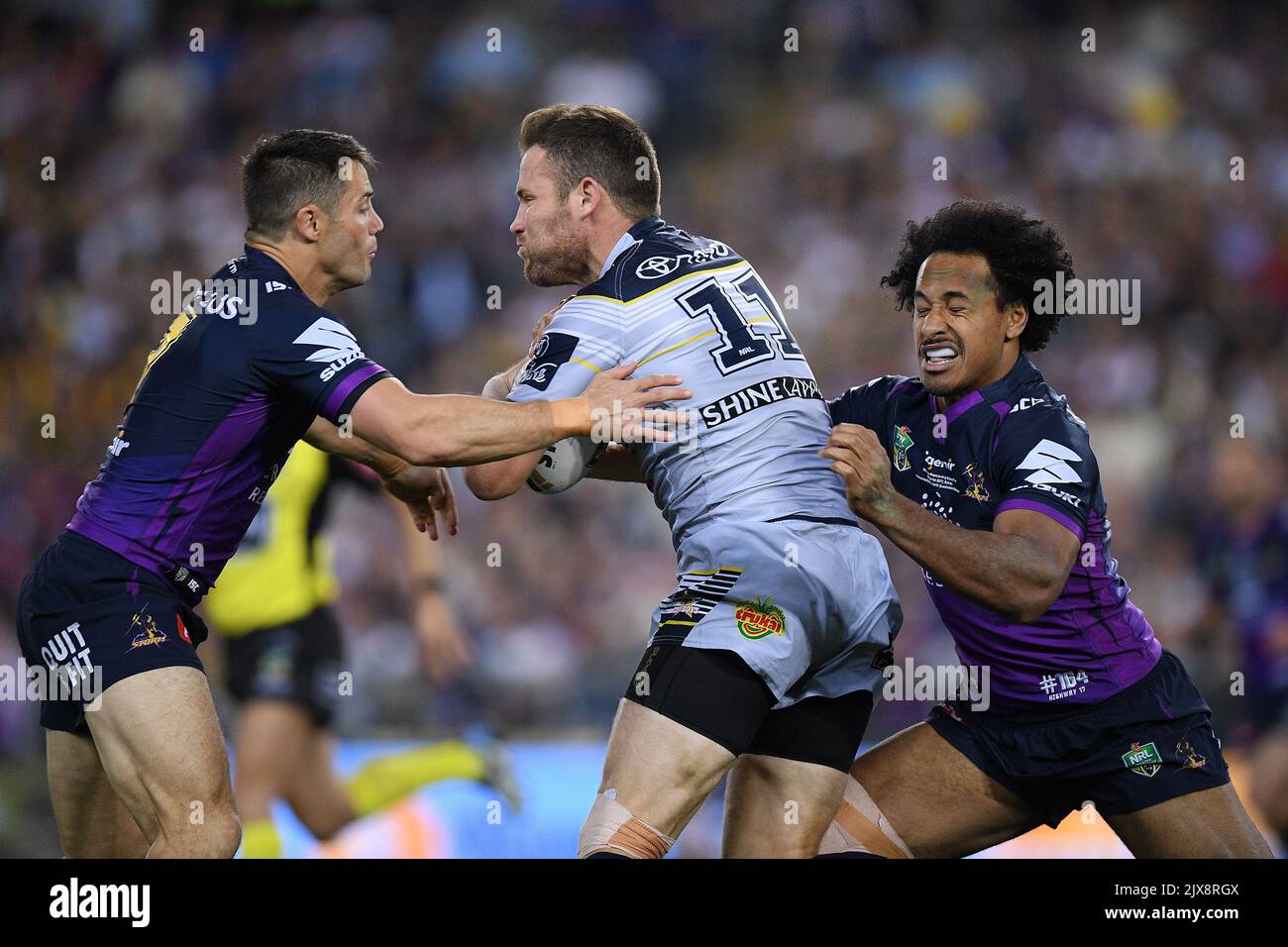 Gavin Cooper of the Cowboys (centre) is talked by Slade Griffin (right ...
