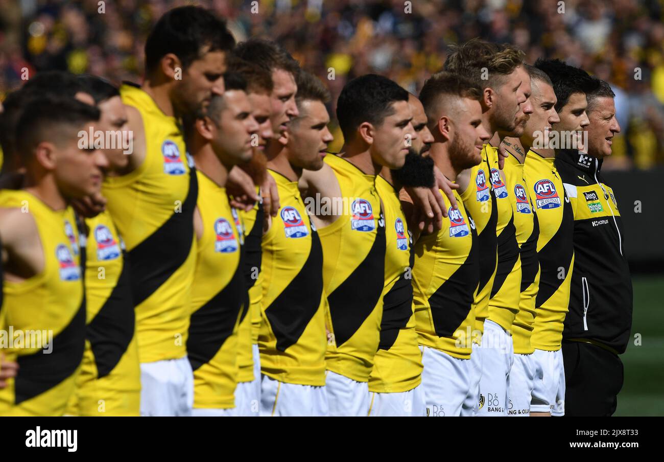 The Tigers players and coach Damien Hardwick (right) are during the ...