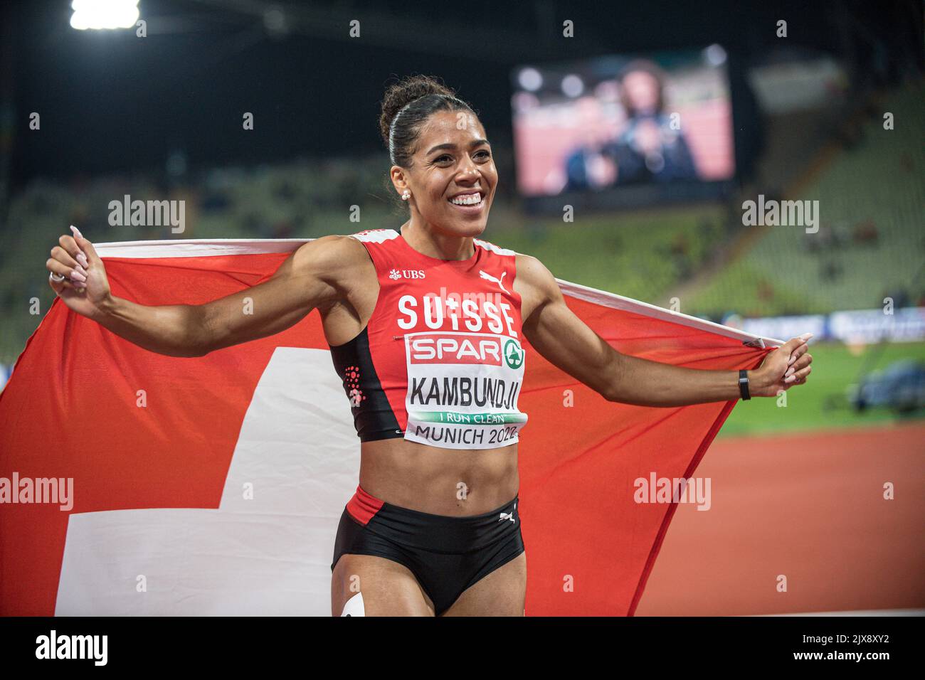 Mujinga Kambundji with her country's flag as the winner of the 100 ...