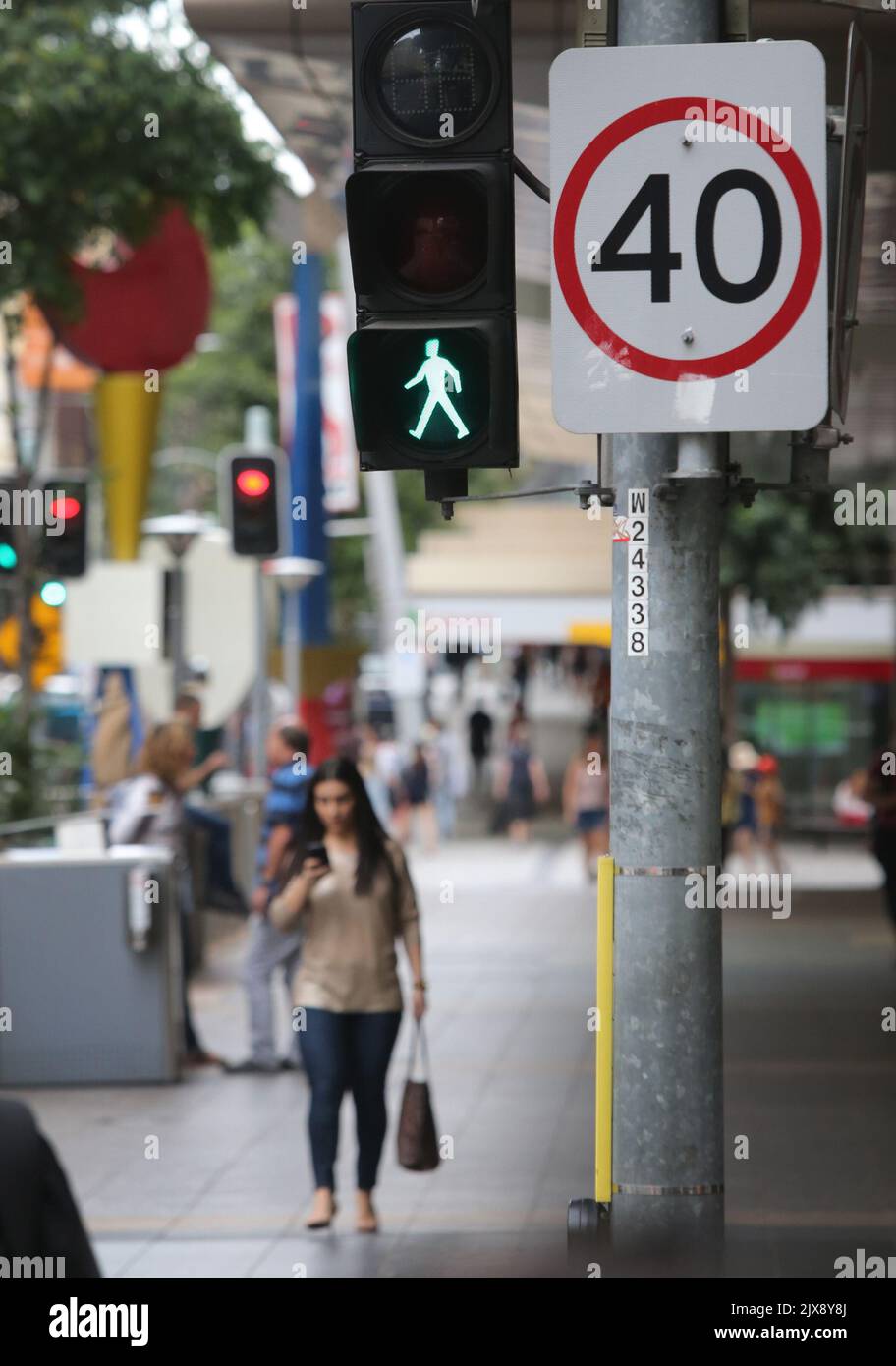 A stock image of a green pedestrian traffic sign in Brisbane on Sunday ...