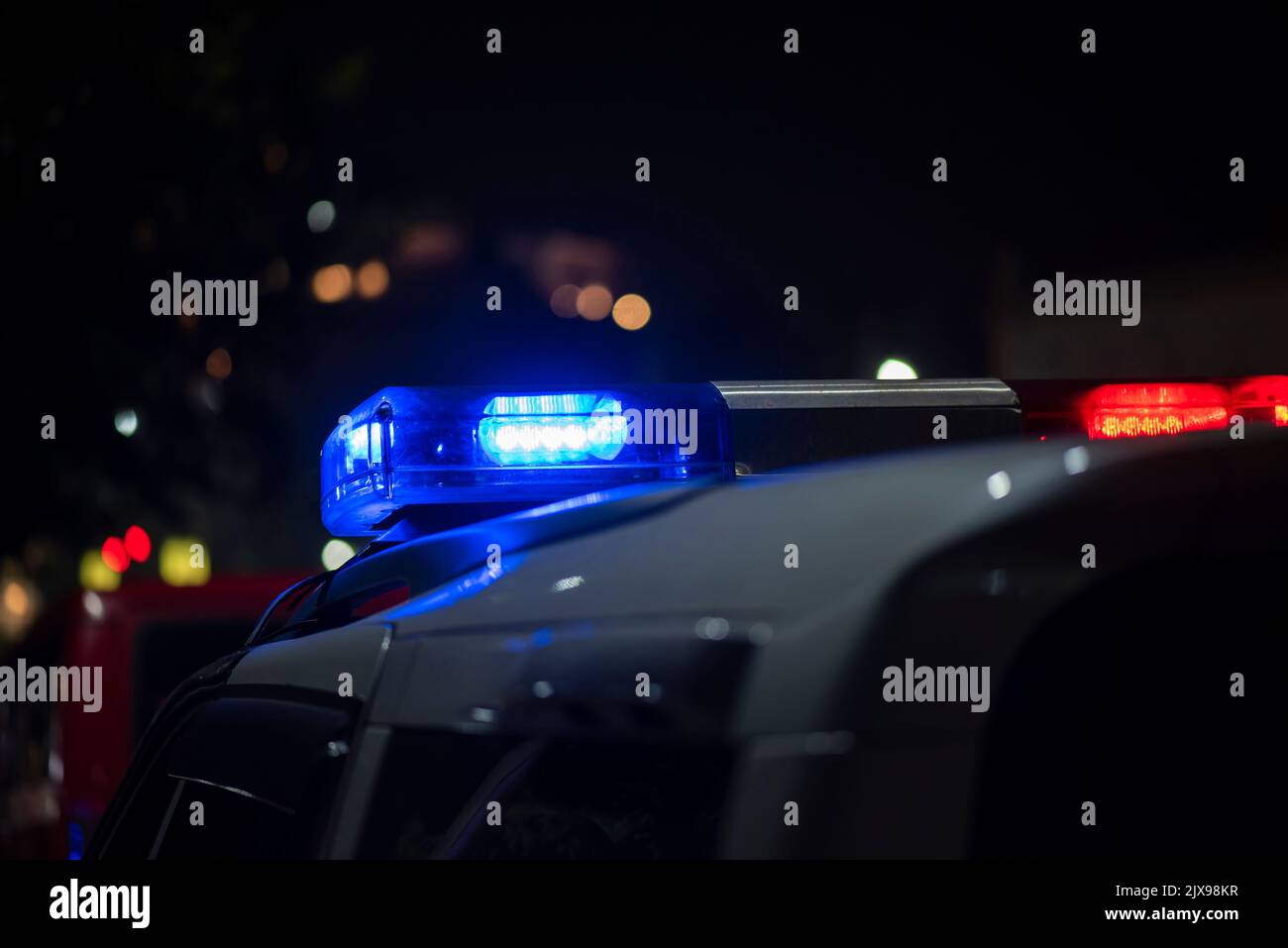 Emergency light of police patrolling car on street in night Stock Photo ...