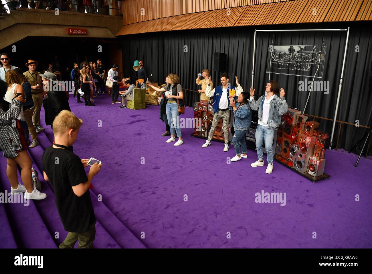 Guests poses for a photograph with models at the Stranger Things season ...