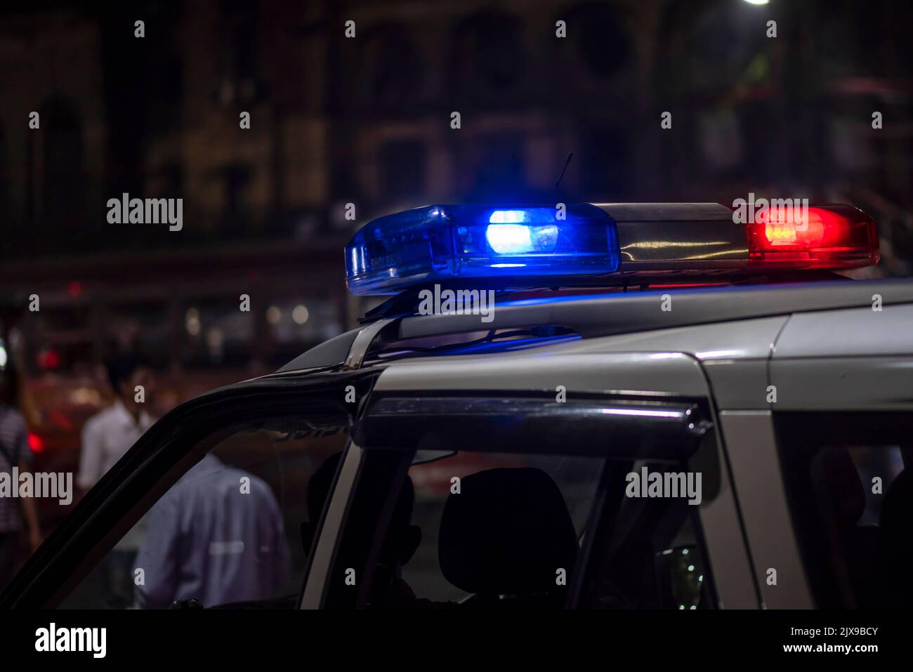 Emergency light of police patrolling car on street in night Stock Photo ...