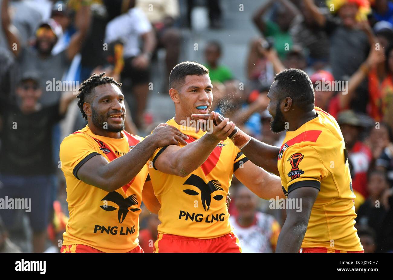 Papua New Guinea's David Mead (centre) celebrates after scoring a try ...