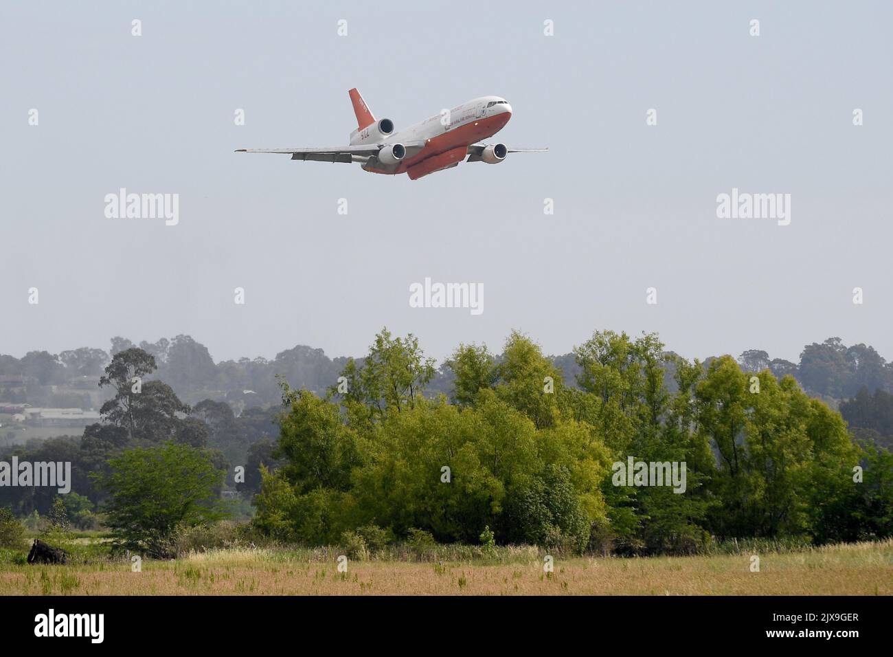 A NSW Rural Fire Service Very Large Air Tanker (VLAT) is seen on a low ...